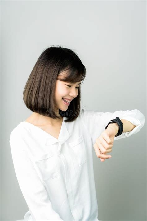 Woman Using A Digital Clock In The Display And Technology Advances In Communication Stock Photo