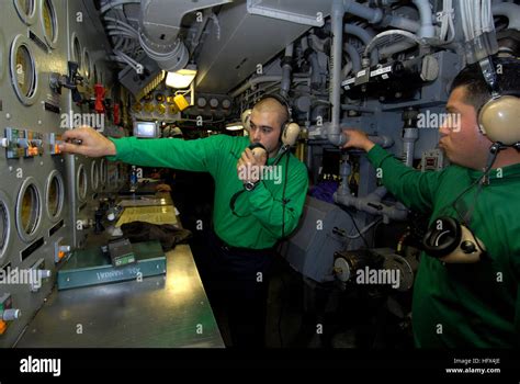 Uss Nimitz Cvn 68 Crew Members Stand Watch In The Catapult Engine