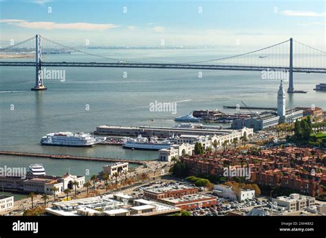 The San Francisco Oakland Bay Bridge Is Perched Above The Embarcadero