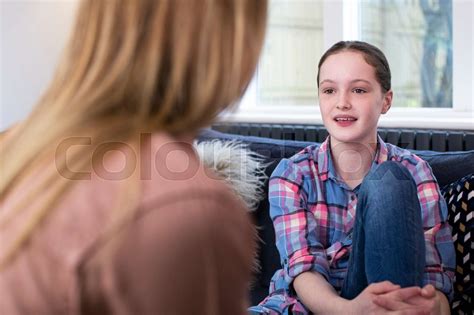 Mother Having Serious Conversation With Young Daughter At Home Stock