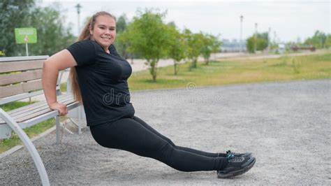 Young Fat Woman Doing Push Ups From The Bench Outdoors Chubby Girl