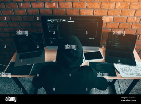 Hacker In The Hood Working With Computer With Hacking Breaking Into Data Servers Stock Photo Alamy
