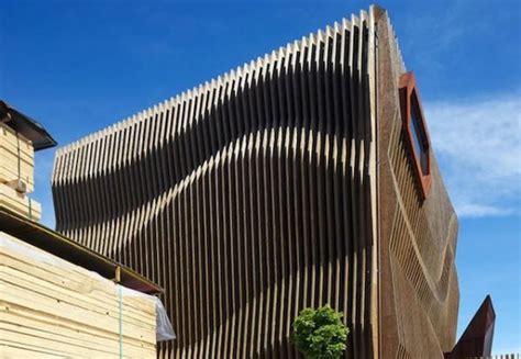 Wave Like Effect Attained By Using Wooden Louvers That Also Shades The Interior From Sun