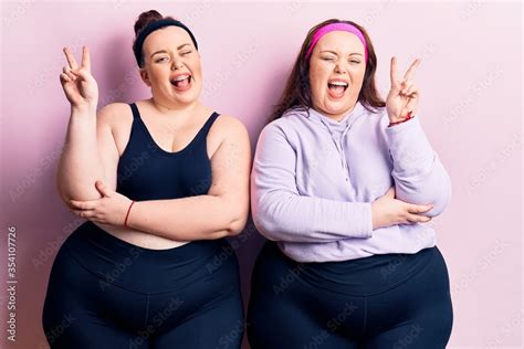 Babe Plus Size Twins Wearing Sportswear Smiling With Happy Face Winking At The Camera Doing