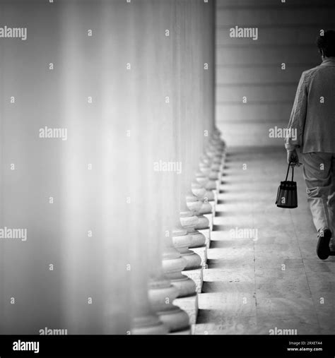 Rear View Of A Person Among Neoclassical Architectural Columns Stock Rear View Of A Person Among Neoclassical Architectural Columns Stock