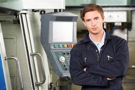 Engineer Instructing Trainee On Use Of Computerized Cutting Mach Stock