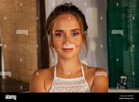 Woman Relaxing In Bath With Tropical Flowers Outdoor At Luxury Hotel