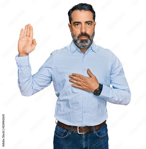 Middle Aged Man With Beard Wearing Business Shirt Swearing With Hand On