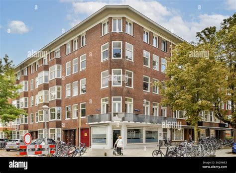 A Striking Example Of Modern Urban Architecture Showcases Large Windows And A Unique Triangular