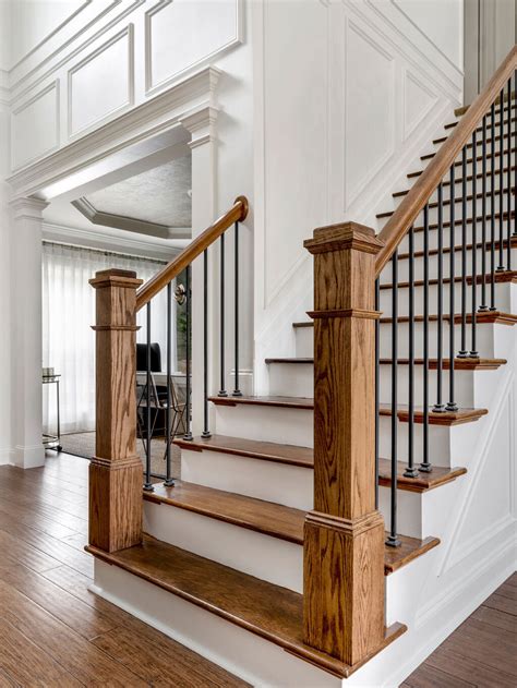 Traditional Staircase Design With Oak Handrail And Iron Balusters