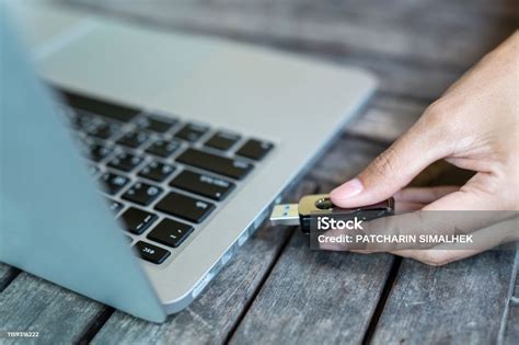 Hand Inserting Usb Flash Drive Into Computer Laptop On The Desk Computer Hacker And Technology