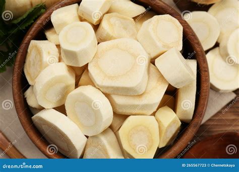Cut Fresh Ripe Parsnip In Bowl On Wooden Table Top View Stock Image