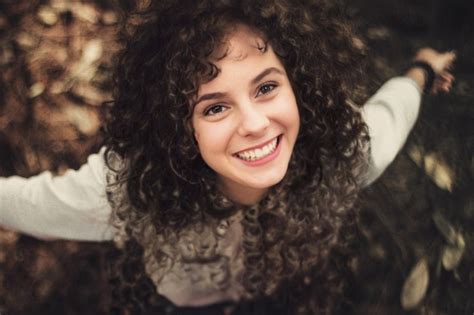Premium Photo Beautiful Curly Haired Girl Posing For The Camera