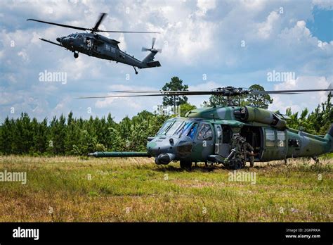 An Hh 60w Jolly Green Ii Left Lands Next To An Hh 60g Pave Hawk