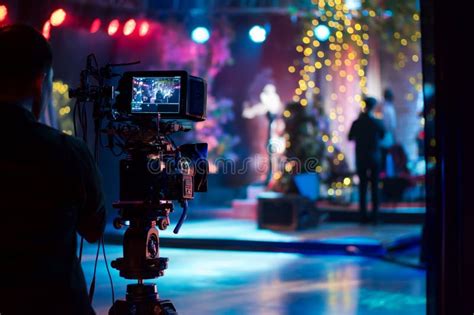 Video Camera Operator Working With His Equipment At Indoor Event Cameraman Is Filming An