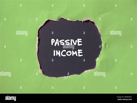 Passive Income Words Written On Green Torn Paper With Black Background