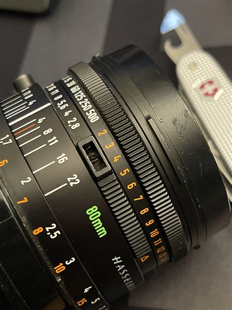 Button For Cross Coupling Of Shutter Speed And Aperture Rings Is