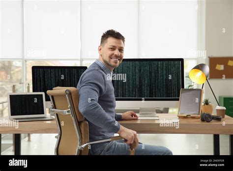 Happy Programmer Working At Desk In Office Stock Photo Alamy