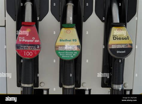 Three Fuelling Nozzles With Gasoline And Diesel Of Shell Company Attached To Fuel Pump Dispenser
