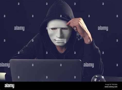 Masked Man Hacking Server In Dark Room Stock Photo Alamy