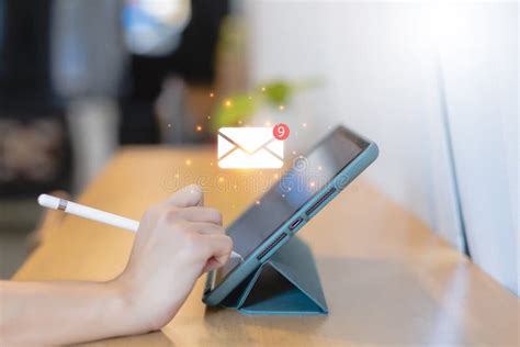 female using touch tablet screen with virtual mail icons e mail