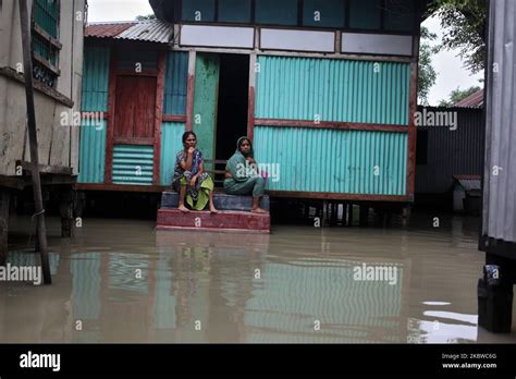 Women Sit At The Entrance Of A House As Flood Situation Worsens At Mawa Area In Munshiganj