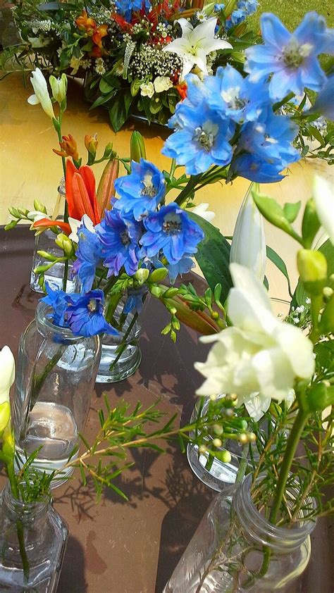 Brides Colors Of Blue Delphinium White And Orange Freesia In Assorted Vases Design By Davis