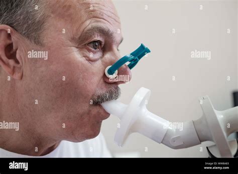 Senior Hispanic Man Man Testing Breathing Function By Spirometry Diagnosis Of Respiratory