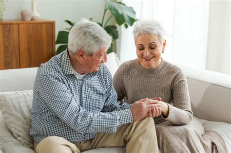 Senior Adult Mature Couple In Love Holding Hands At Home Mid Age Old Husband And Wife Looking