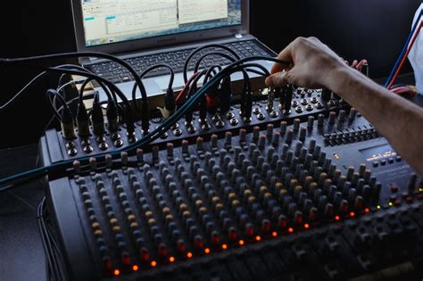 Premium Photo Sound Engineer Plugging Jack Audio Cable On Studio Mixer