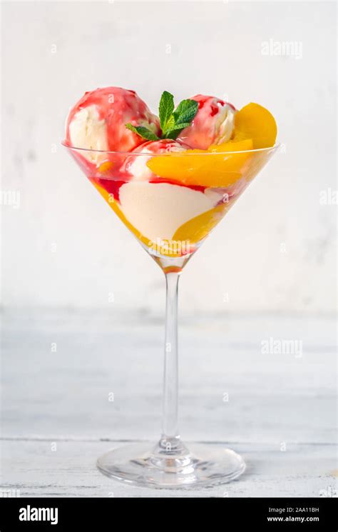 Peach Melba Dessert Of Peaches And Raspberry Sauce With Vanilla Ice