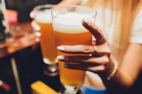 Waiter Serving Glasses Of Cold Beer On The Tray Premium Photo