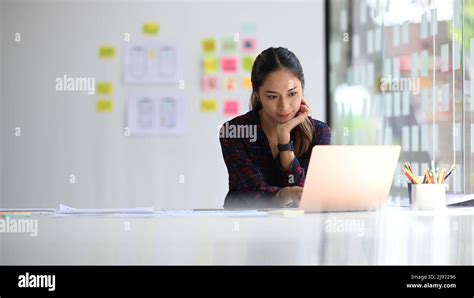 Concentrated Female Web Developer Working On Mobile Application Software Design Project At