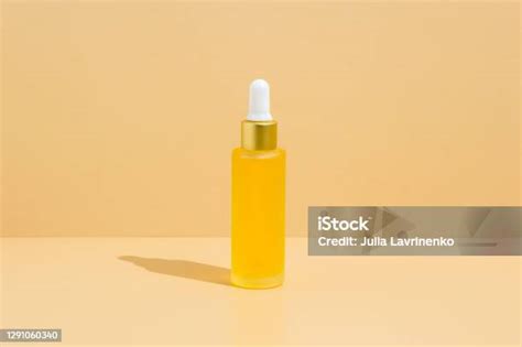 중성 베이지 색 배경에 노란색 세럼 또는 에센셜 오일의 드롭퍼 병 비타민 C 웰니스 스파 뷰티 트리트먼트 컨셉의 유기농 스킨 케어 화장품 제품 모형 0명에 대한 스톡 사진