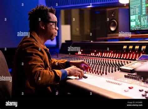 African American Sound Designer Uses Control Desk With Automatic