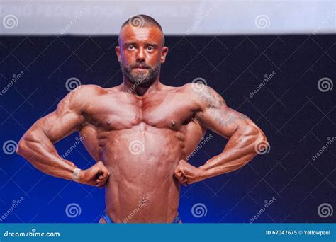 Male Bodybuilder Flexes His Muscles To Show His Physique Editorial