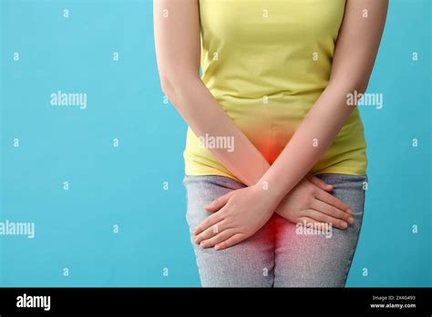 Woman Suffering From Cystitis Symptoms On Light Blue Background