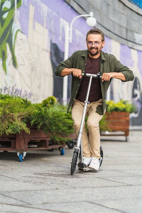 Man On A Scooter Performing Stunts With A Big Wheel Scooter With A