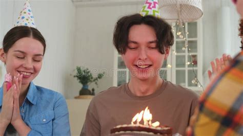 Make A Wish Man Wearing Party Cap Blowing Out Burning Candles On