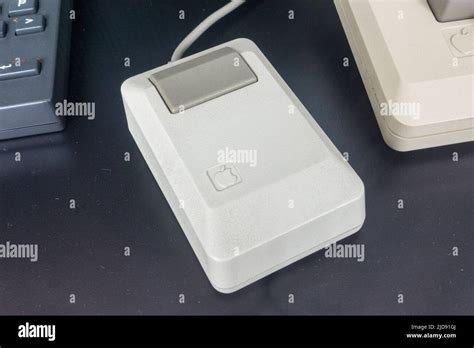 The Mouse Graphical Interface Beside An Original Apple Macintosh 1984 Computer Designed By