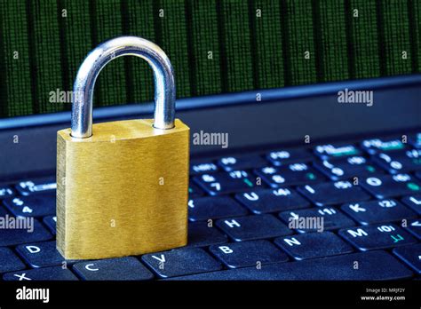 Golden Padlock On Computer Laptop Keyboard With Binary Data Running And