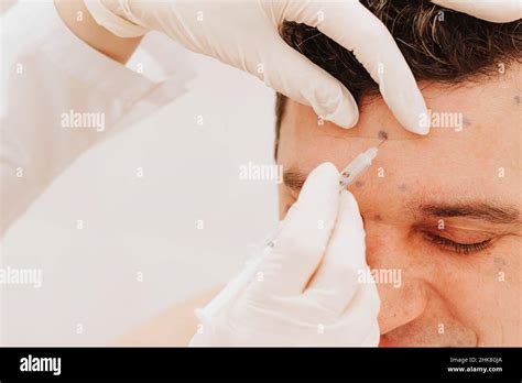 Cosmetologist Conducts Rejuvenation Procedure Puts Botox Injection On Man The Concept