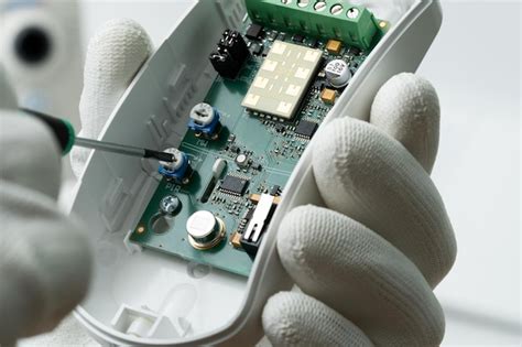 Premium Photo Setting Up A Motion Sensor For Security Systems Before