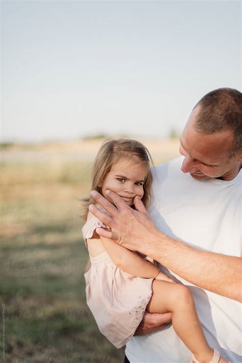 Father Trying To Make His Daughter Smile By Stocksy Contributor