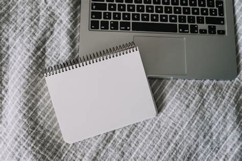 Premium Photo Opened Notebook With A Blank Page Next To A Laptop