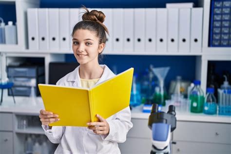 Premium Photo Adorable Girl Scientist Reading Book Studying At Laboratory