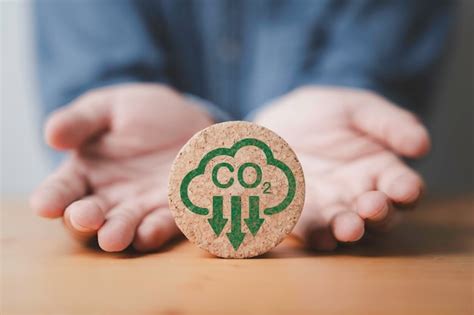 Premium Photo Co2 Reducing Icon On Round Wooden For Decrease Co2 Carbon Footprint And Carbon