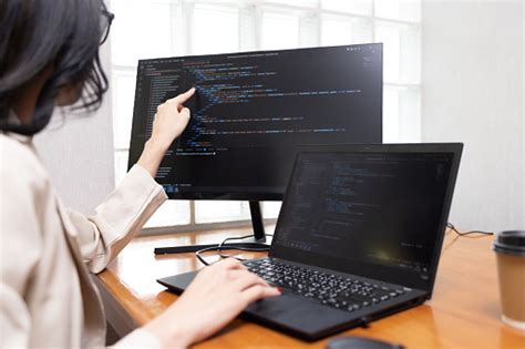 Asian Programmer Woman Working On Computer And Typing Source Code For