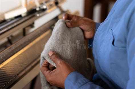 Woman Textile Worker Using Weaving Machine With Patterns On A Piece Of