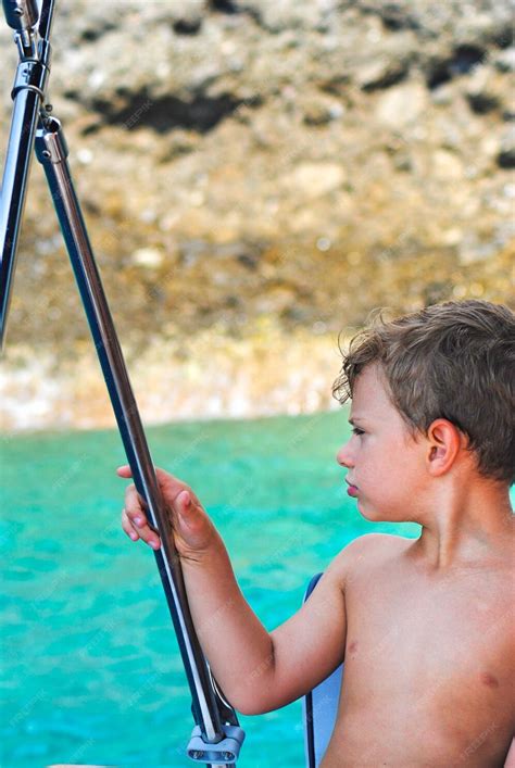 Premium Photo Shirtless Boy Looking At Sea